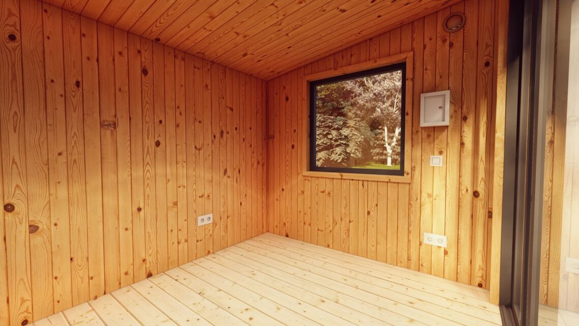Wooden frame sauna, painted in green with white details, with a terrace ...